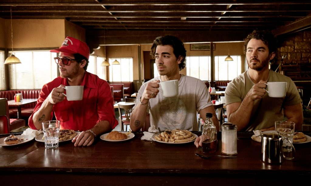 Jonas Brothers Leads A Party Across London In ‘Waffle House’ Video